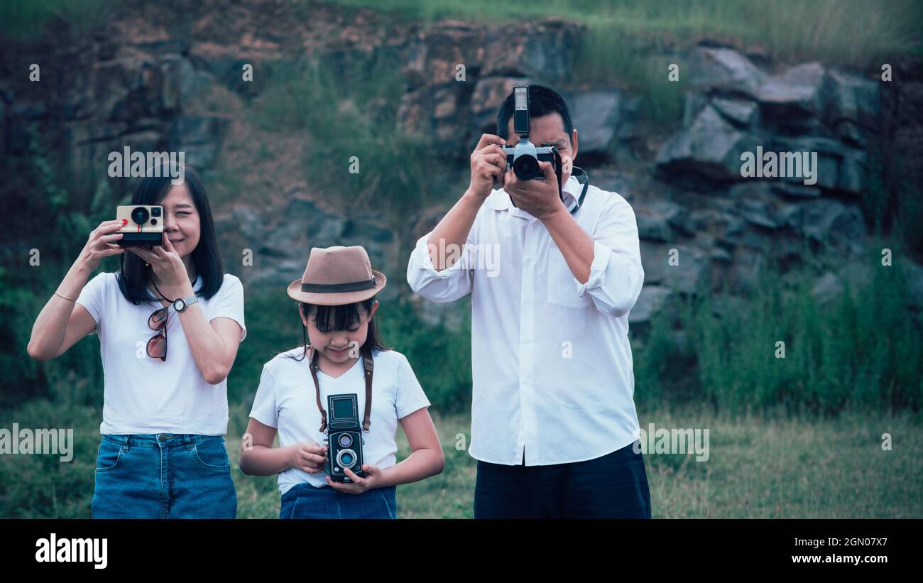 Vintage family of photographers are happily taking pictures with the ...