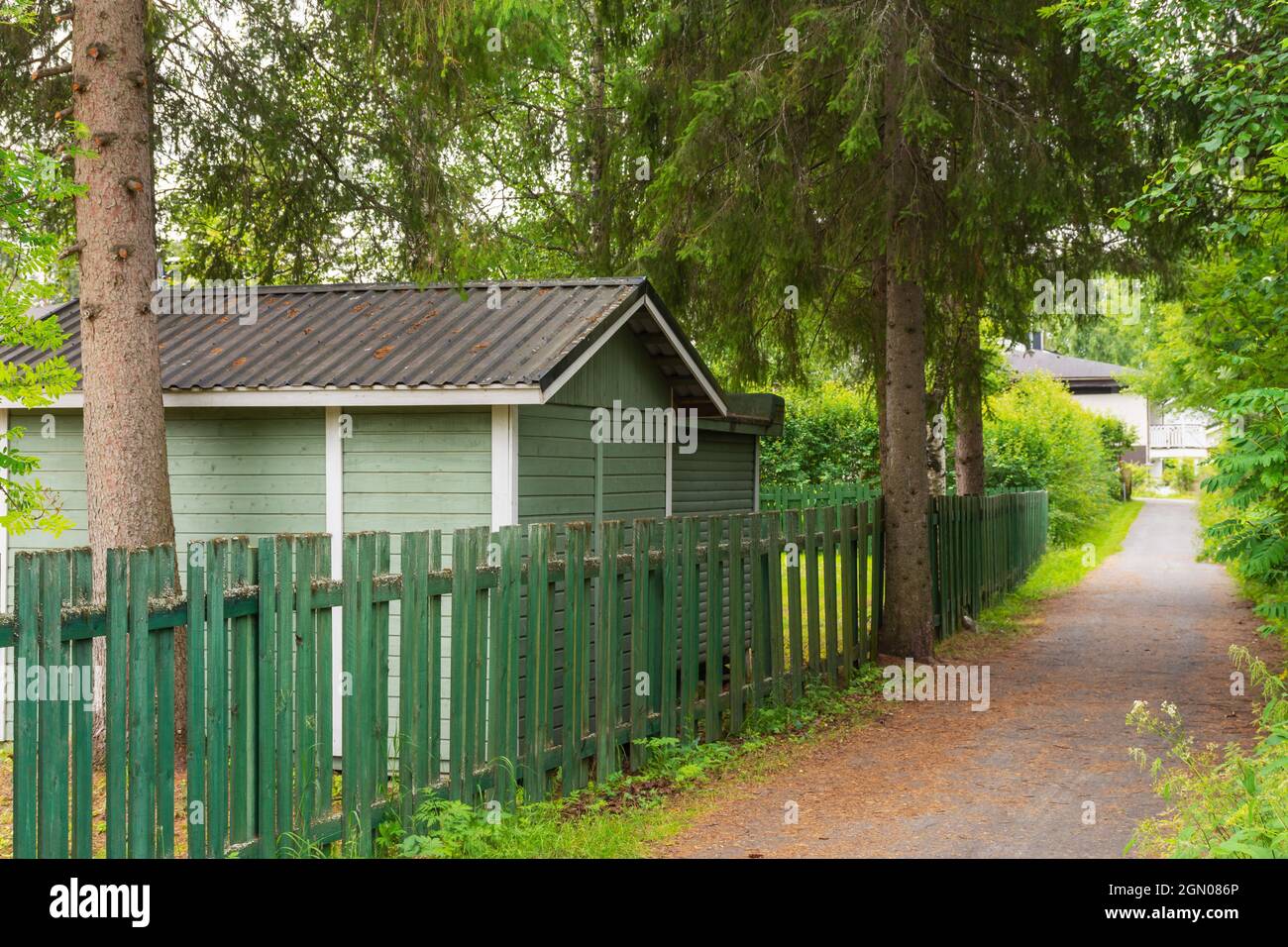 Cycle route by a green plank fence in Ylitornio Finland Stock Photo - Alamy