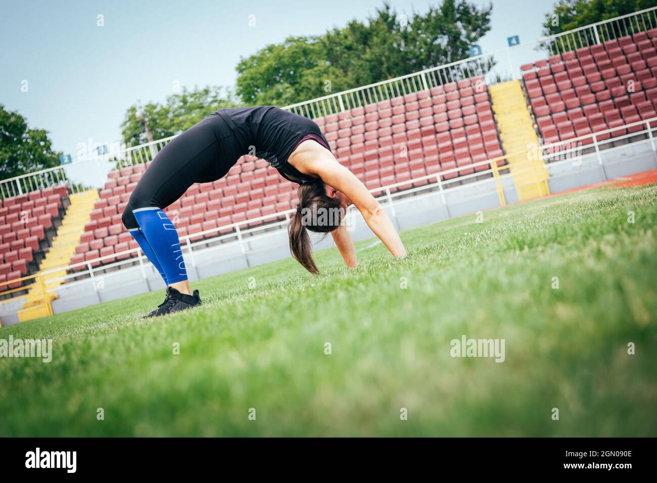 Young athletic woman stretches and prepares to run. strong sport woman ...