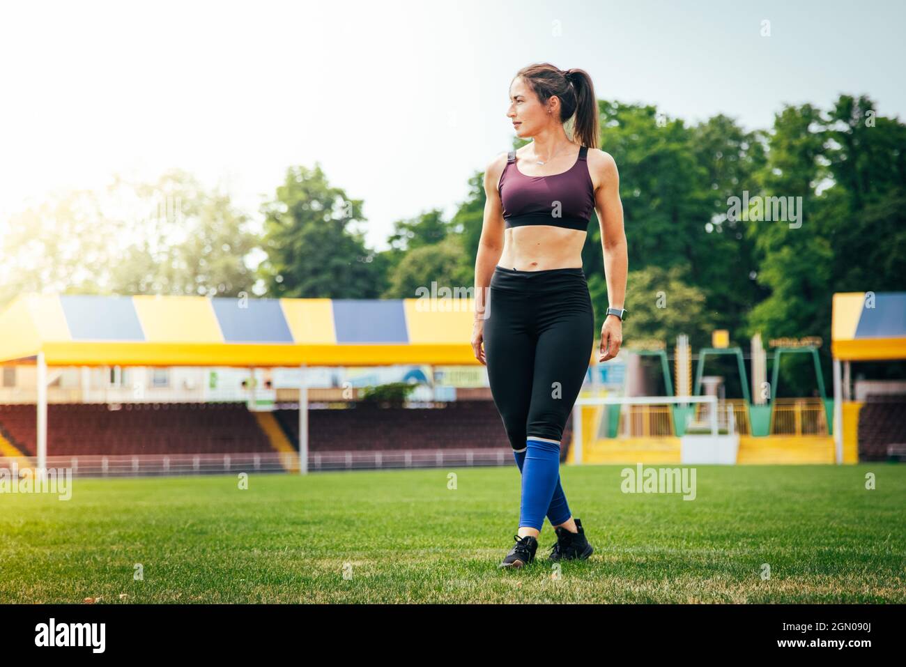 Young athletic woman stretches and prepares to run. strong sport woman ...