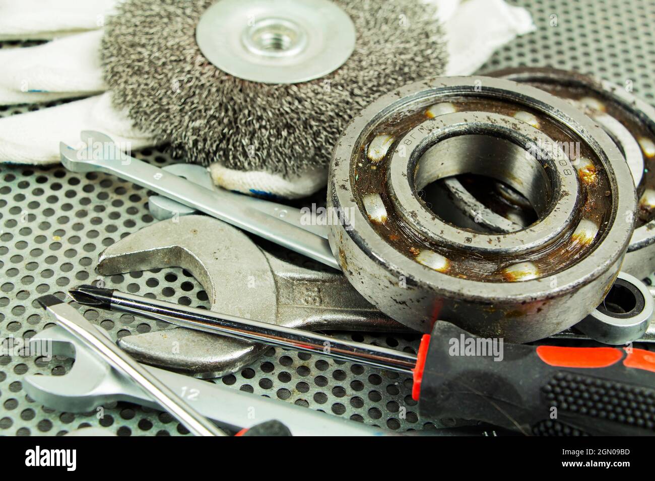 Metalworking tools, steel parts, a wrench, on the background of a metal ...