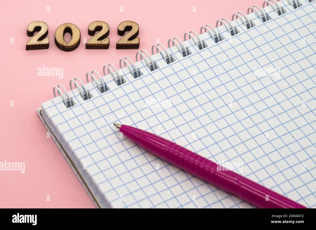 Wooden numbers 2022. Notepad on a spring. Notepad and Pen on Pink. Pink ...