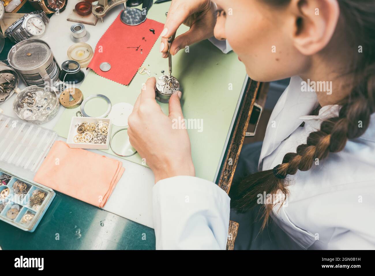 Woman watchmaker working diligently on repairing a watch Stock Photo ...
