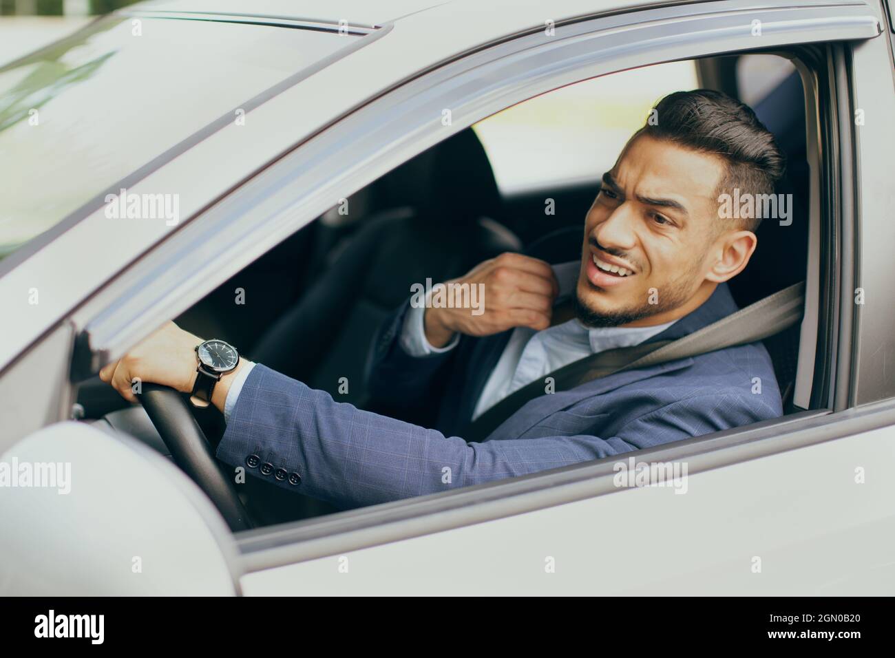 Nervous driver sitting inside car, stuck in traffic Stock Photo - Alamy