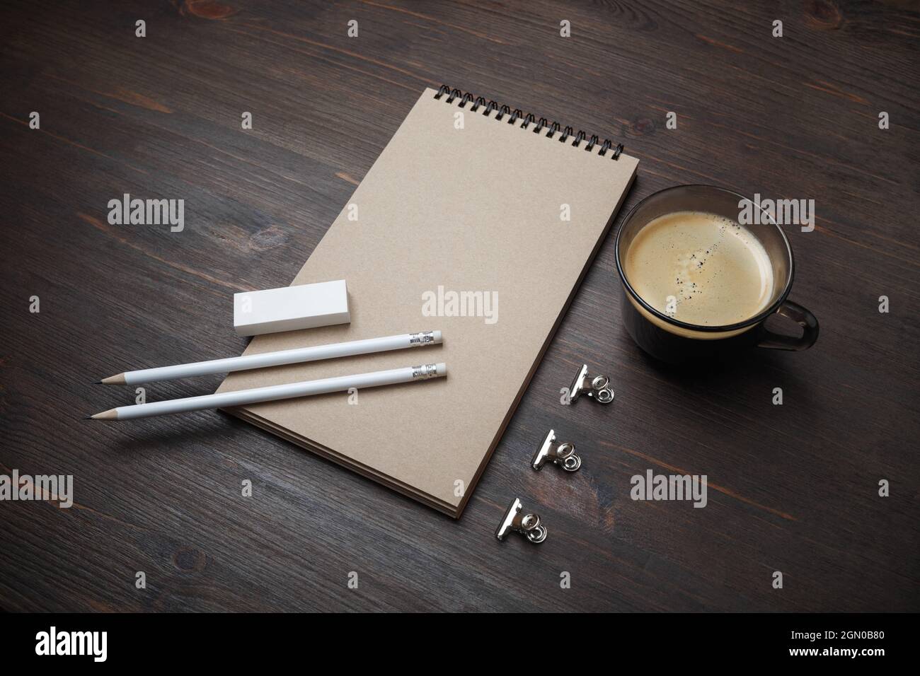 Blank kraft notepad, pencils, eraser and coffee cup on wooden ...