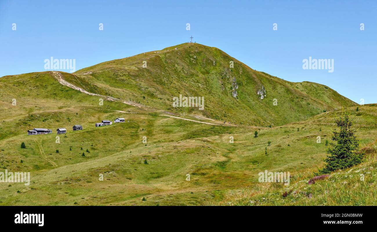 Former alp cabins and path to the peak of the mountain Golzentipp at ...