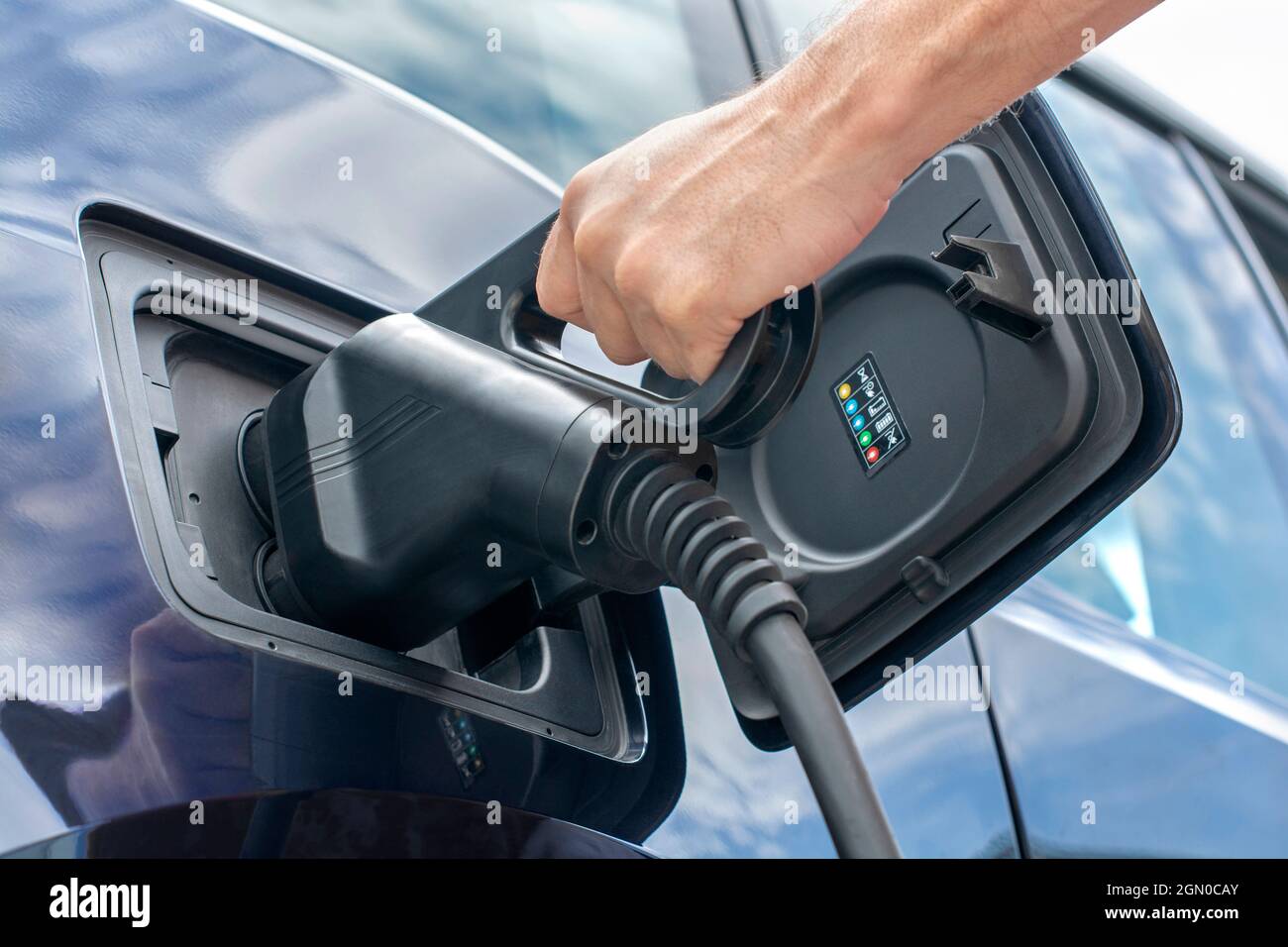 Human hand is holding electric car charging Stock Photo - Alamy