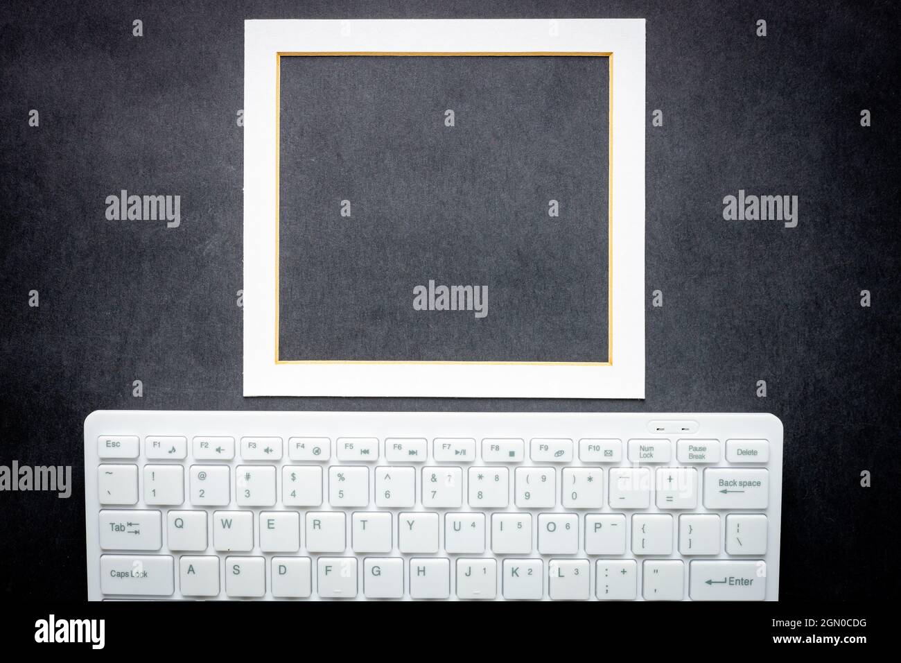 white computer keyboard and a frame for your own text, black background ...