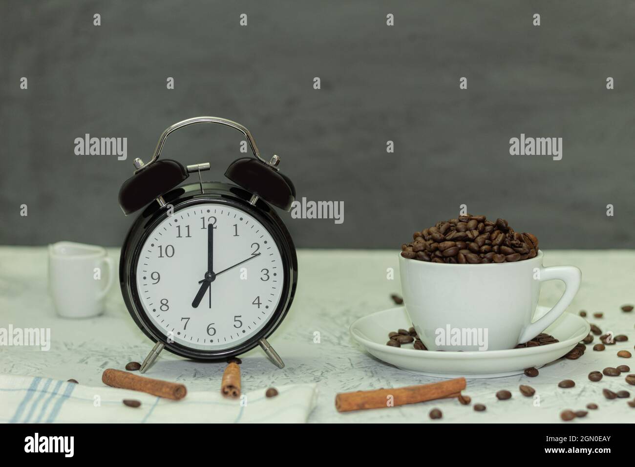 An old alarm clock points to 7.00 and the background has space for text ...