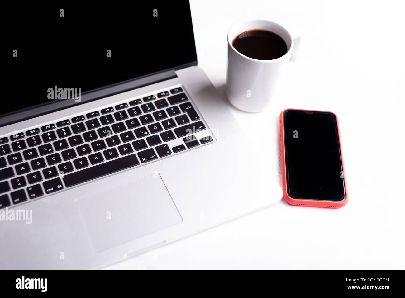 work office desk with a cup of coffee computer laptop and cell phone ...