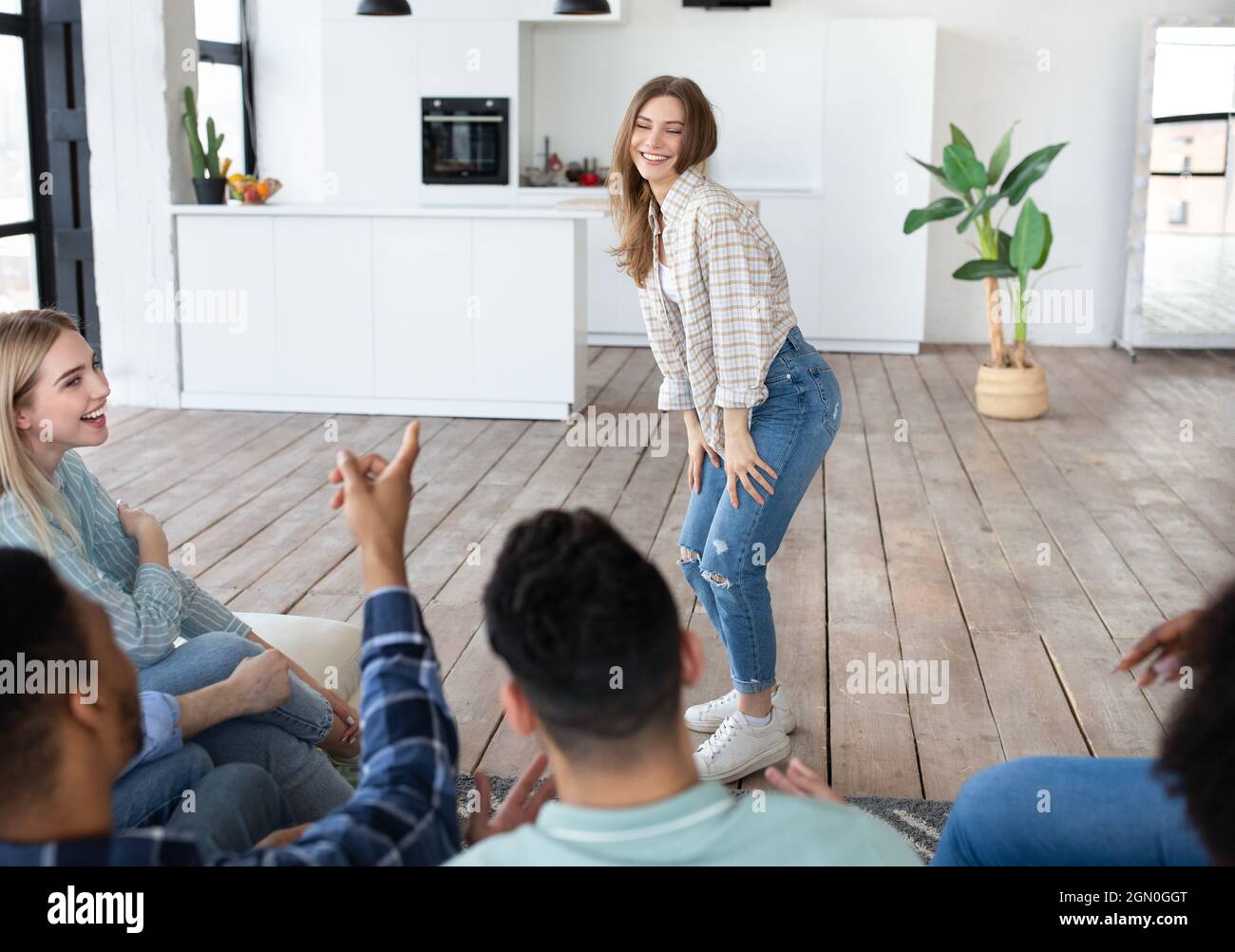 Joyful young Caucasian lady playing word guessing game with her ...