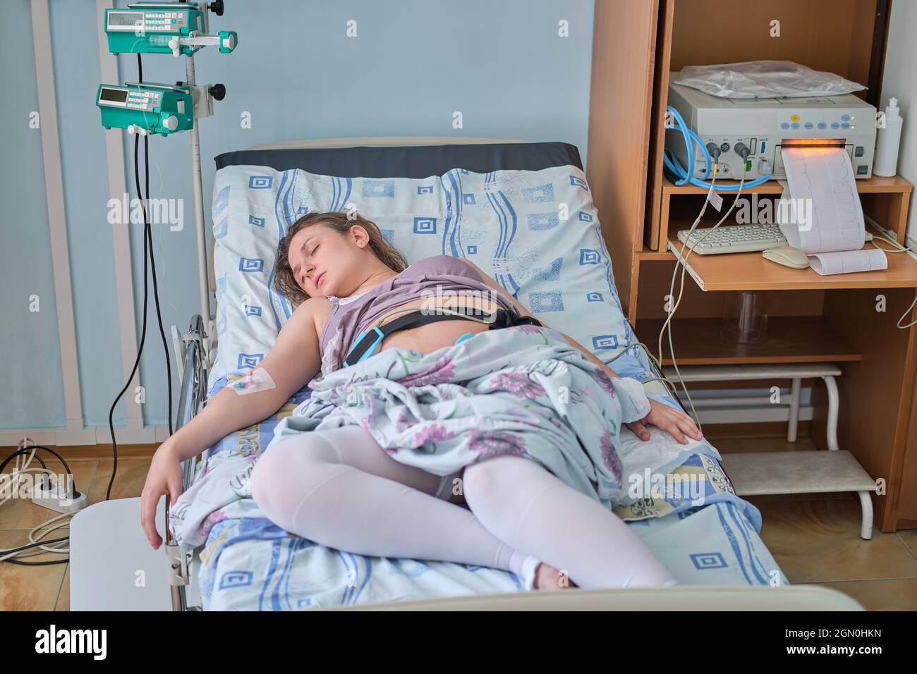 Woman on clinic bed with anesthesia at the time of labor pains. A ...