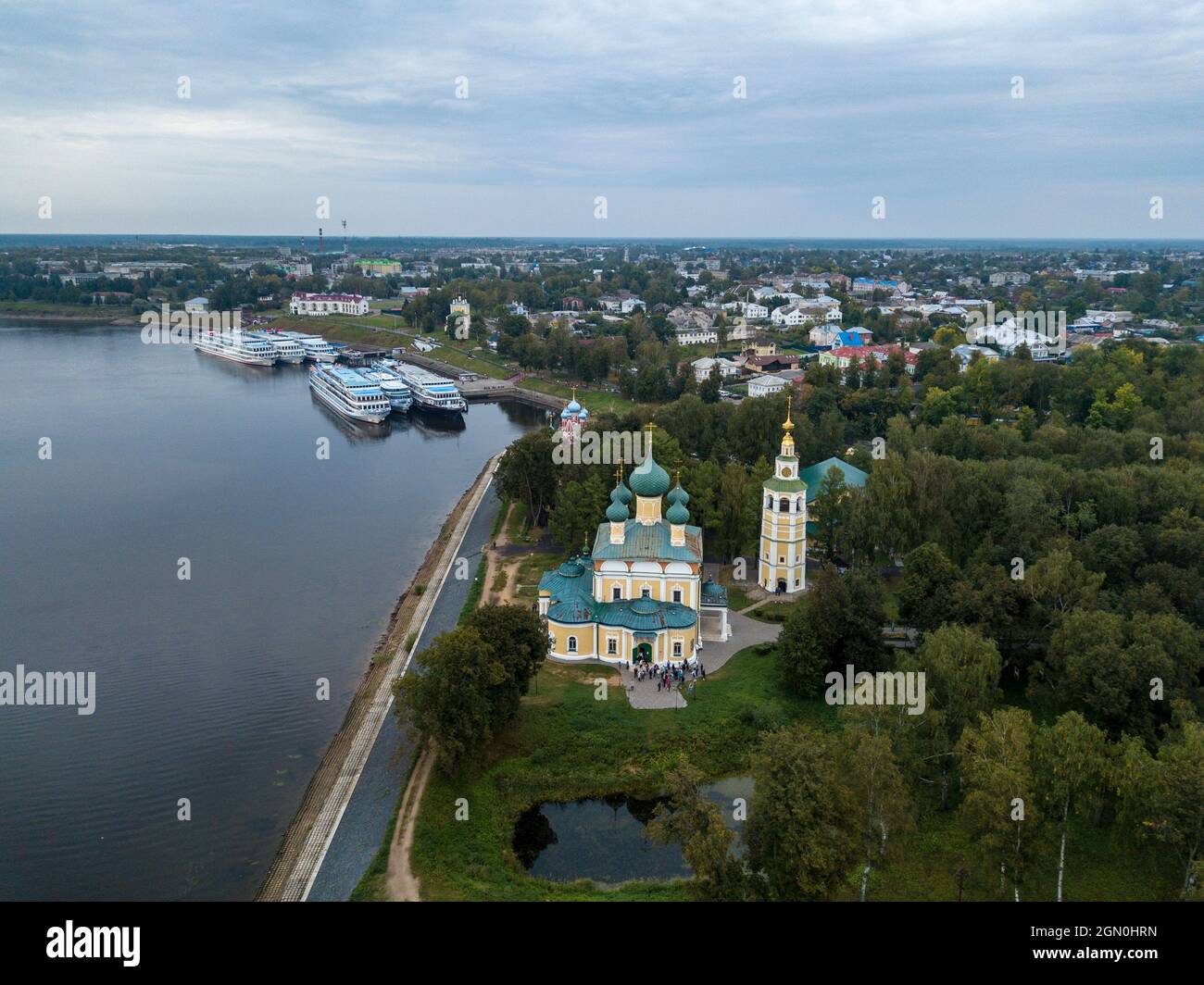 Aerial view of Russian Orthodox Church and river cruise ships docked along Volga River, Uglich ...