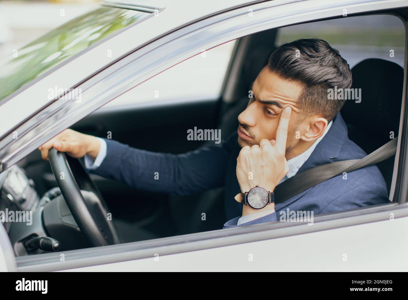 Stressful man going to airport by car, stuck in traffic Stock Photo - Alamy