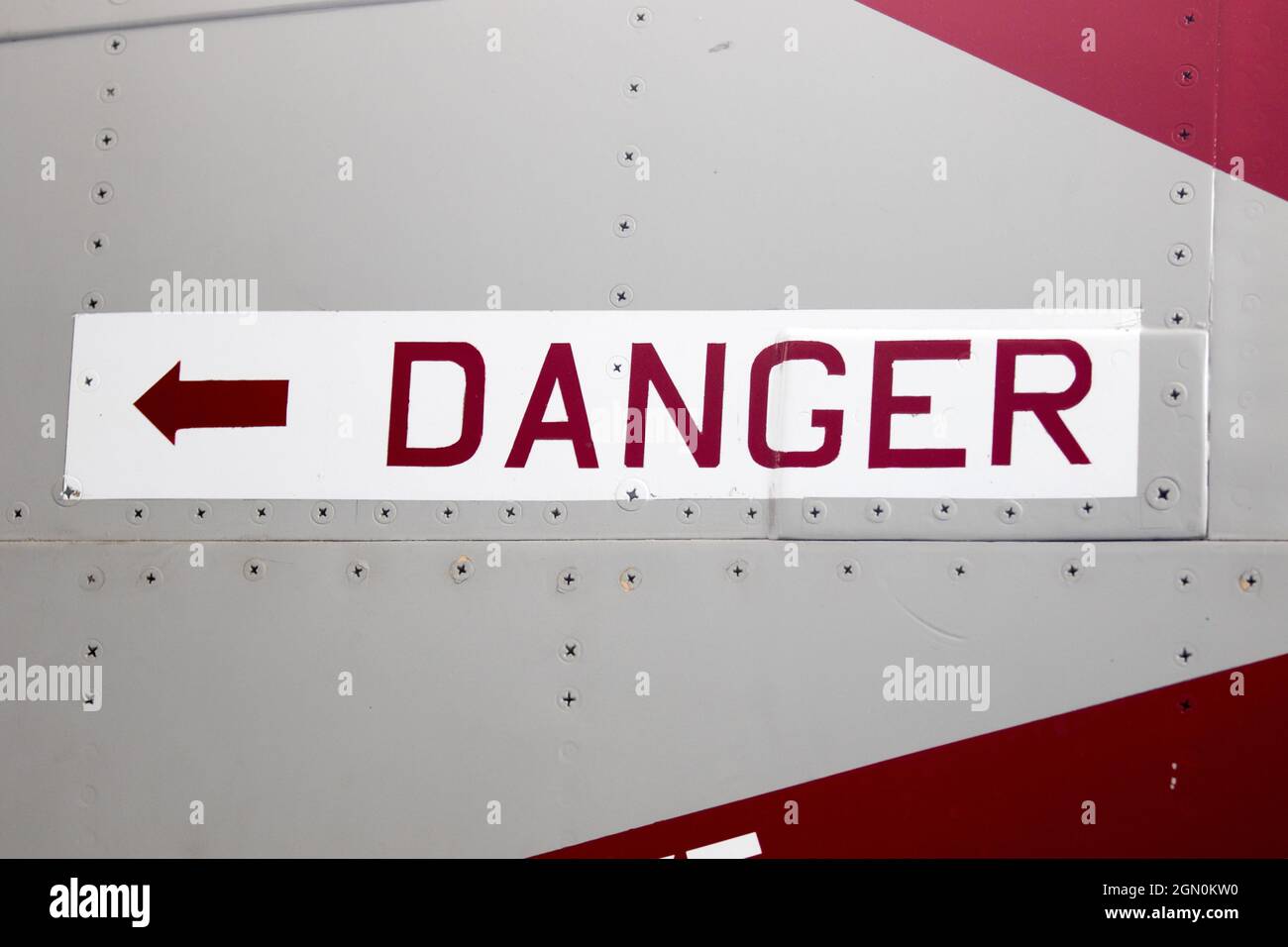 Metallic aircraft fuselage with an arrow indicating the word Danger ...
