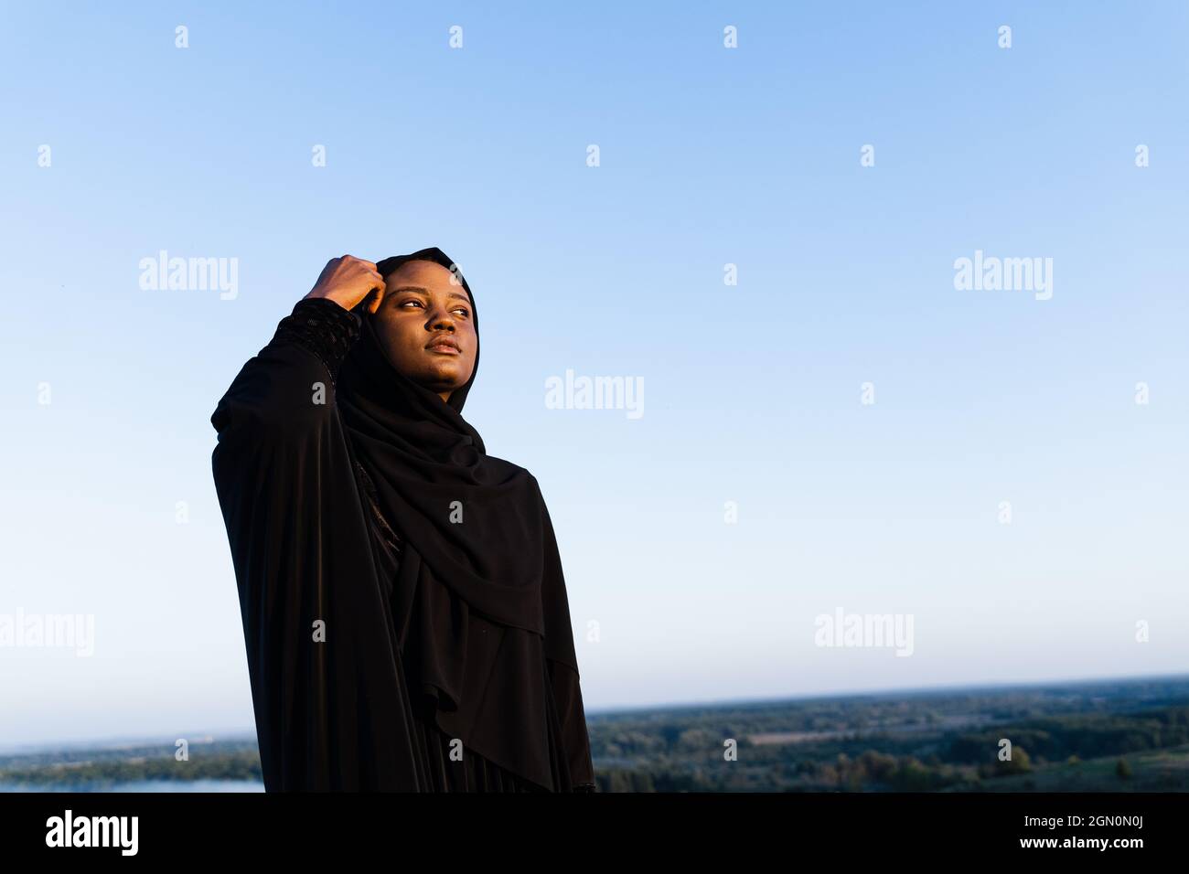 Black muslim woman weared in black robe on blue background. Islamic ...