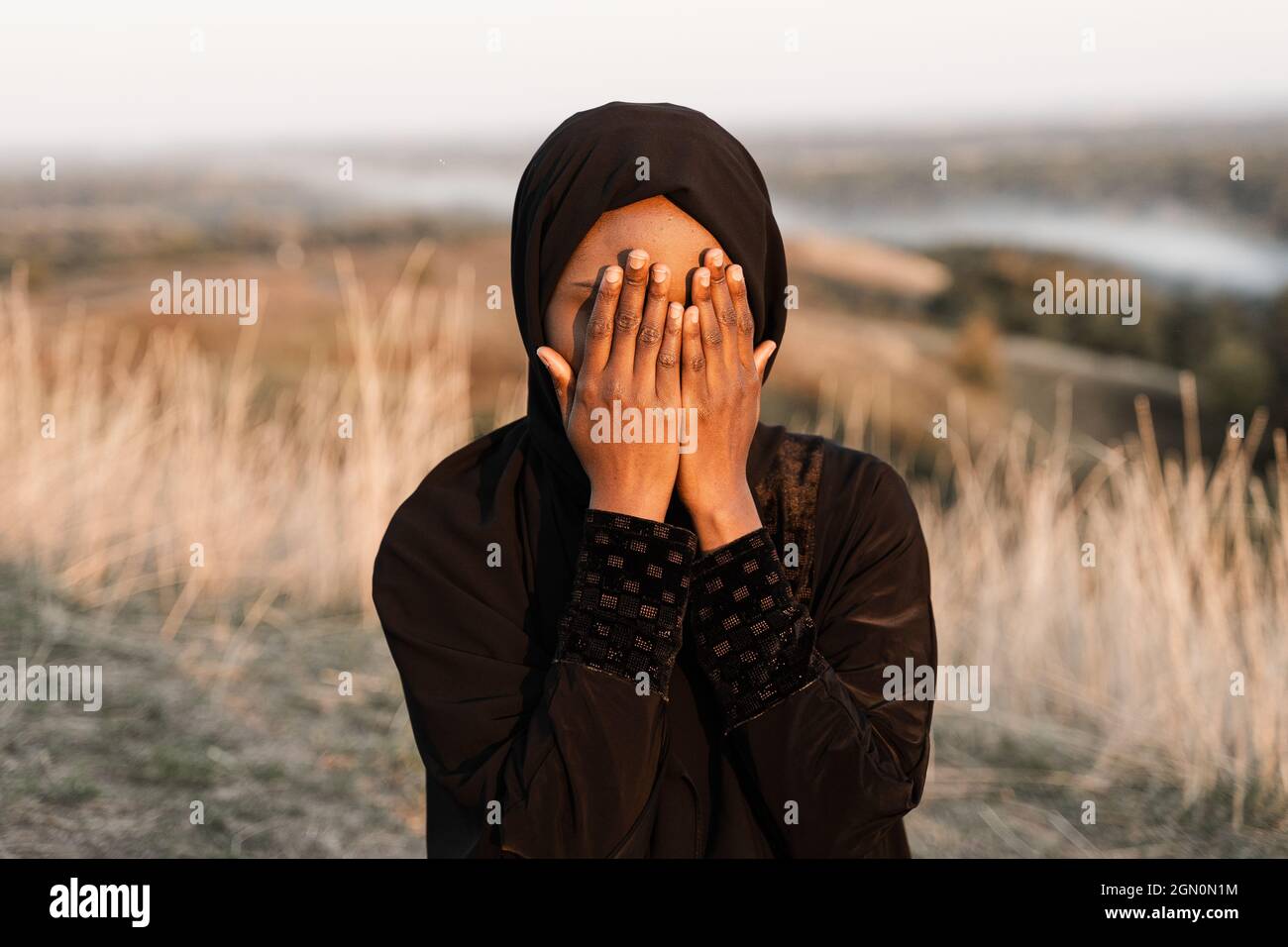 Solat traditional praying to god on the carpet. Black muslim woman ...