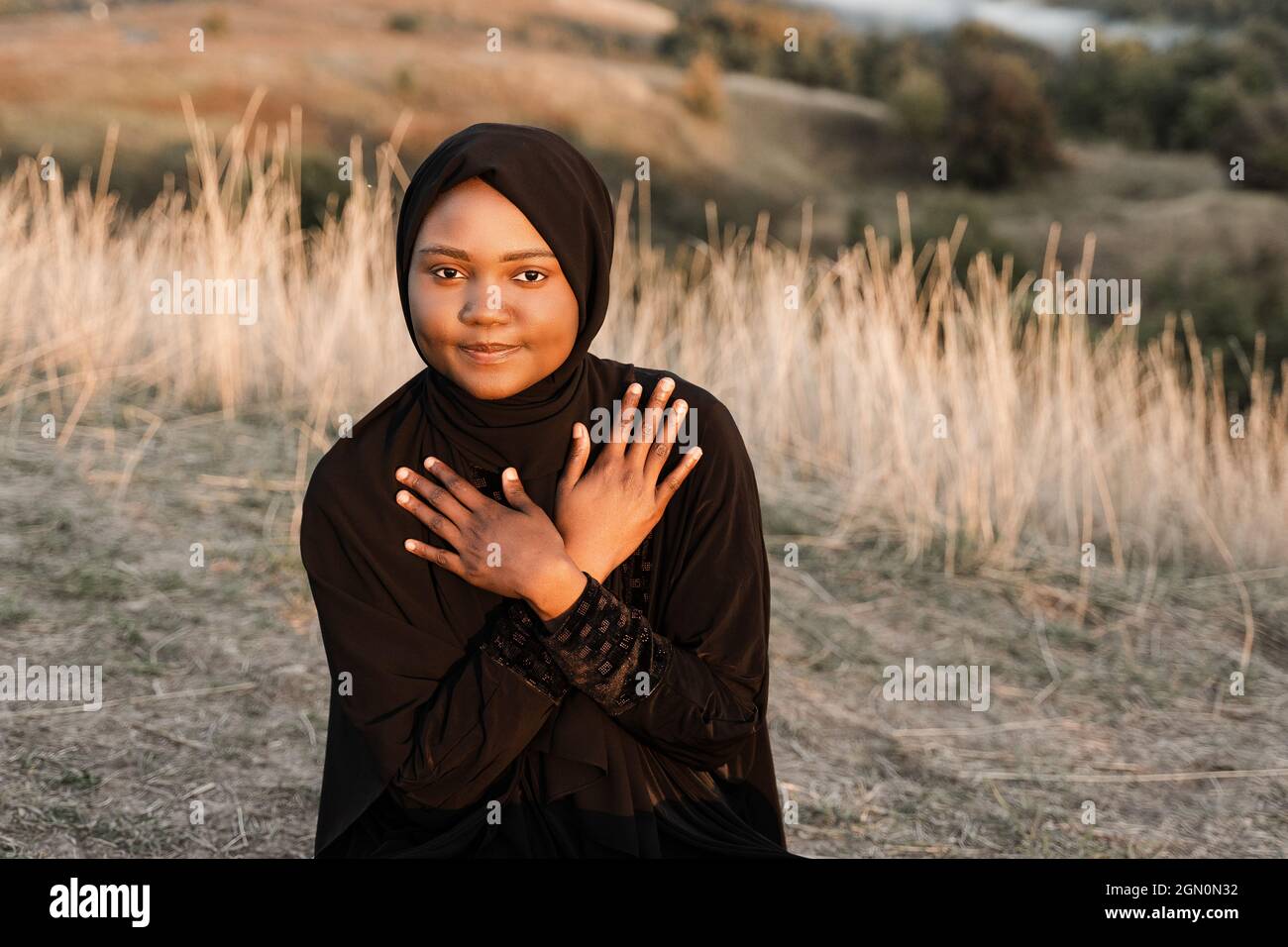 Black muslim woman praying on the carpet. Solat praying on the ...