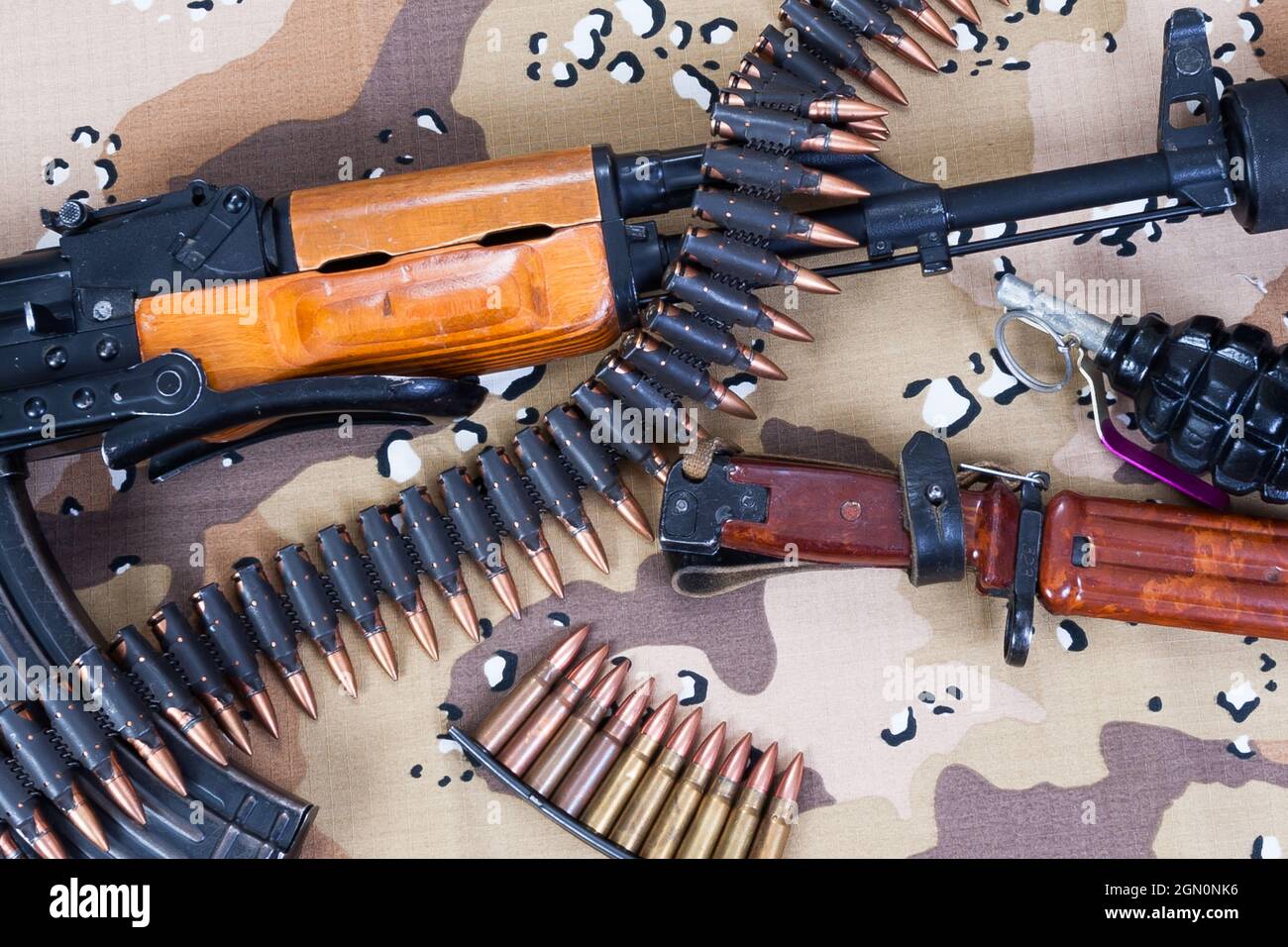 Kalashnikov AKM with ammunitions, hand grenade and bayonet on ...