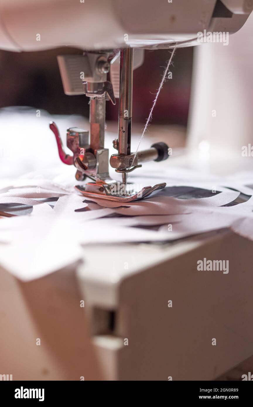 Sewing machine with a needle. Macro photo of a sewing needle. White ...