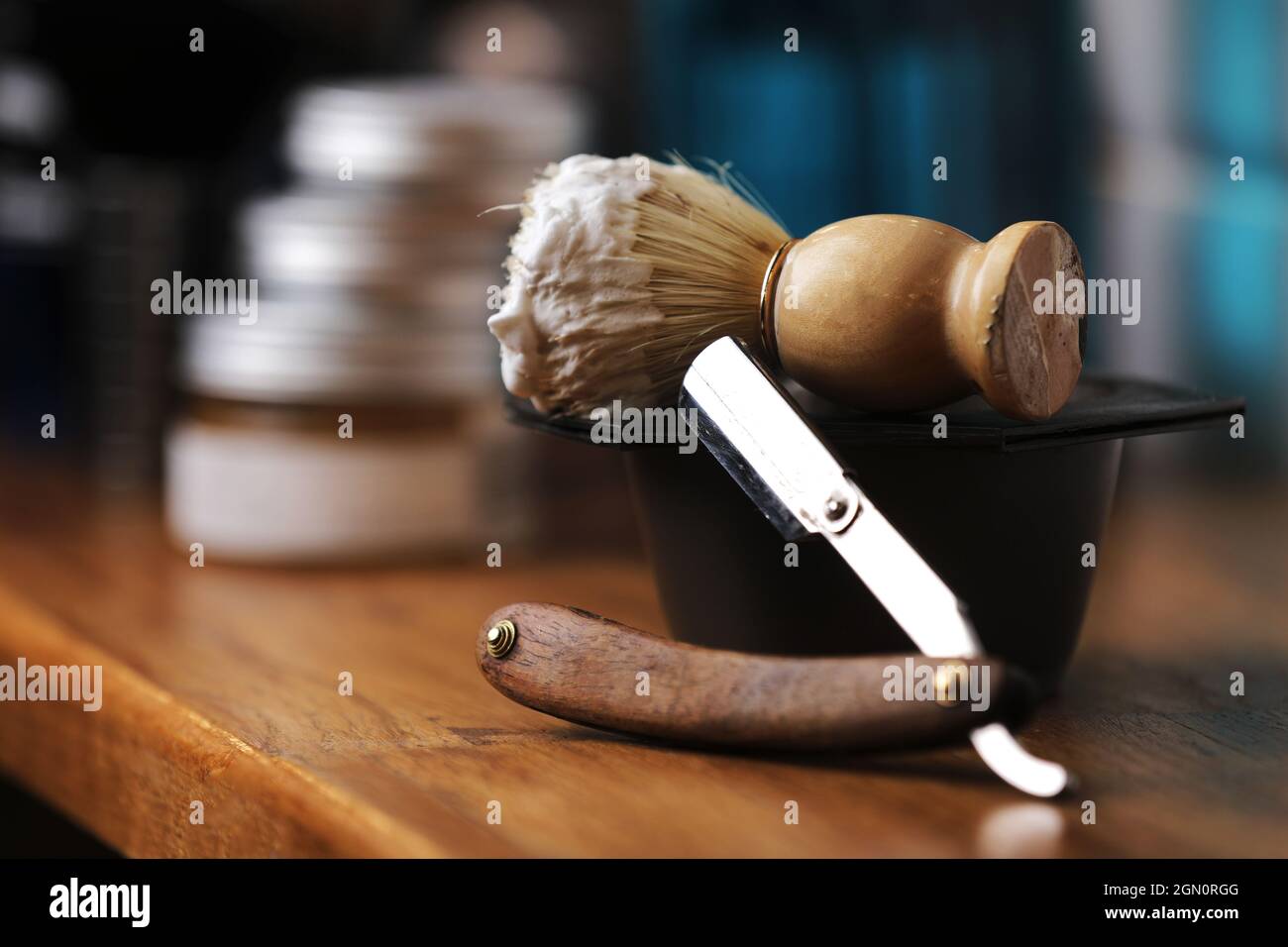 Set of shaving equipment and men's cosmetic products on wooden table ...