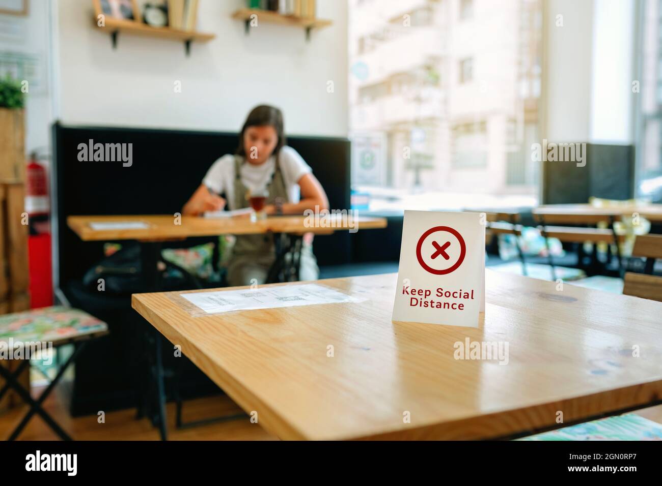 Coffee shop table with do not use sign with girl in background Stock ...
