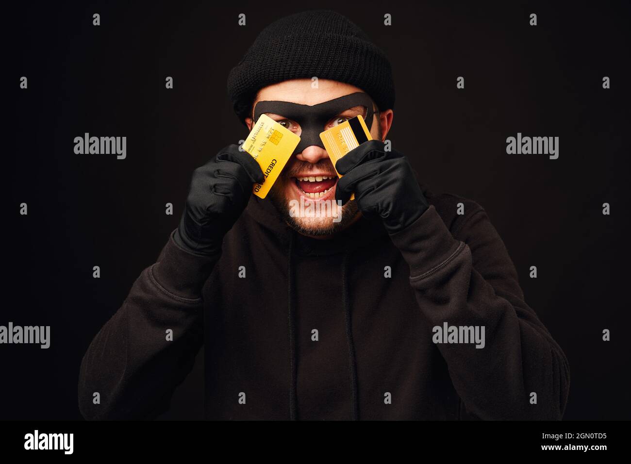 Funny thief holding credit card Stock Photo - Alamy
