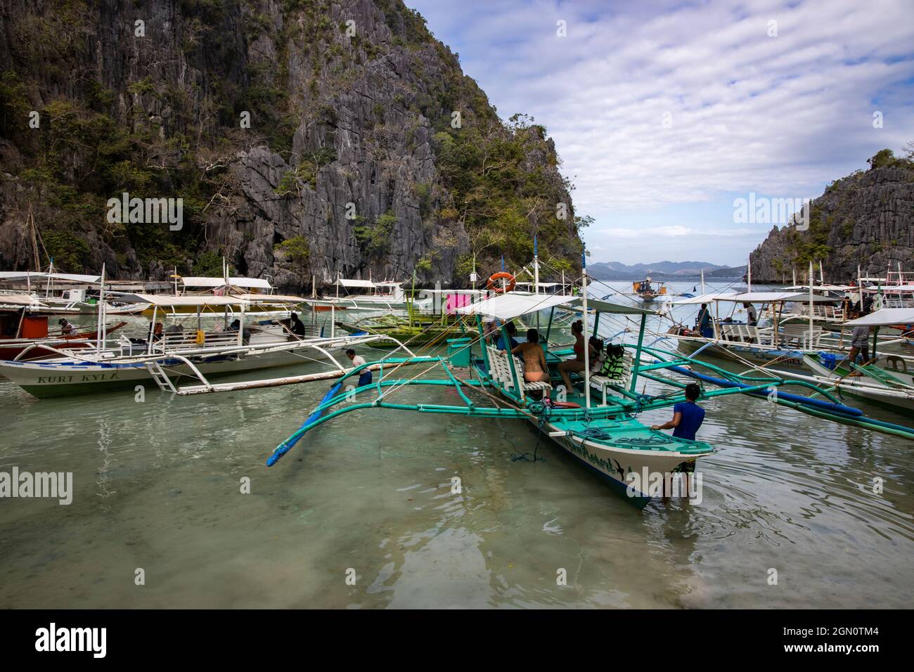 Traditional Filipino Banca outrigger canoes moored in the lagoon near ...
