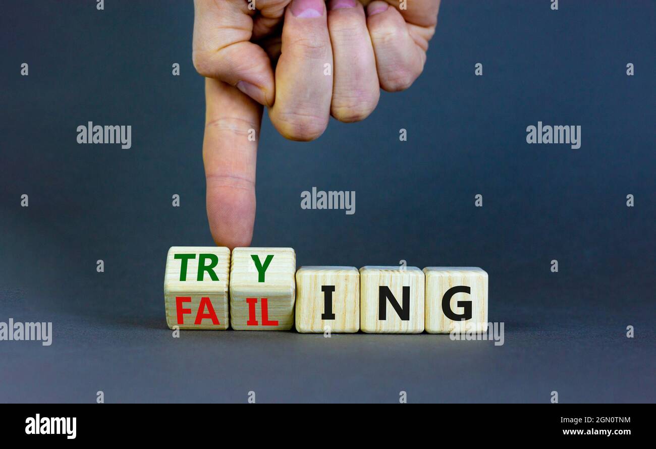 Failing or trying symbol. Businessman turns wooden cubes and changes ...