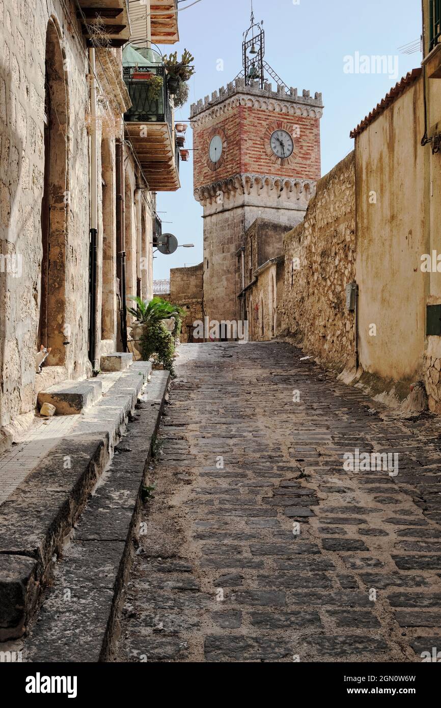 stone architecture in Sicily clock tower in a street of historic centre ...