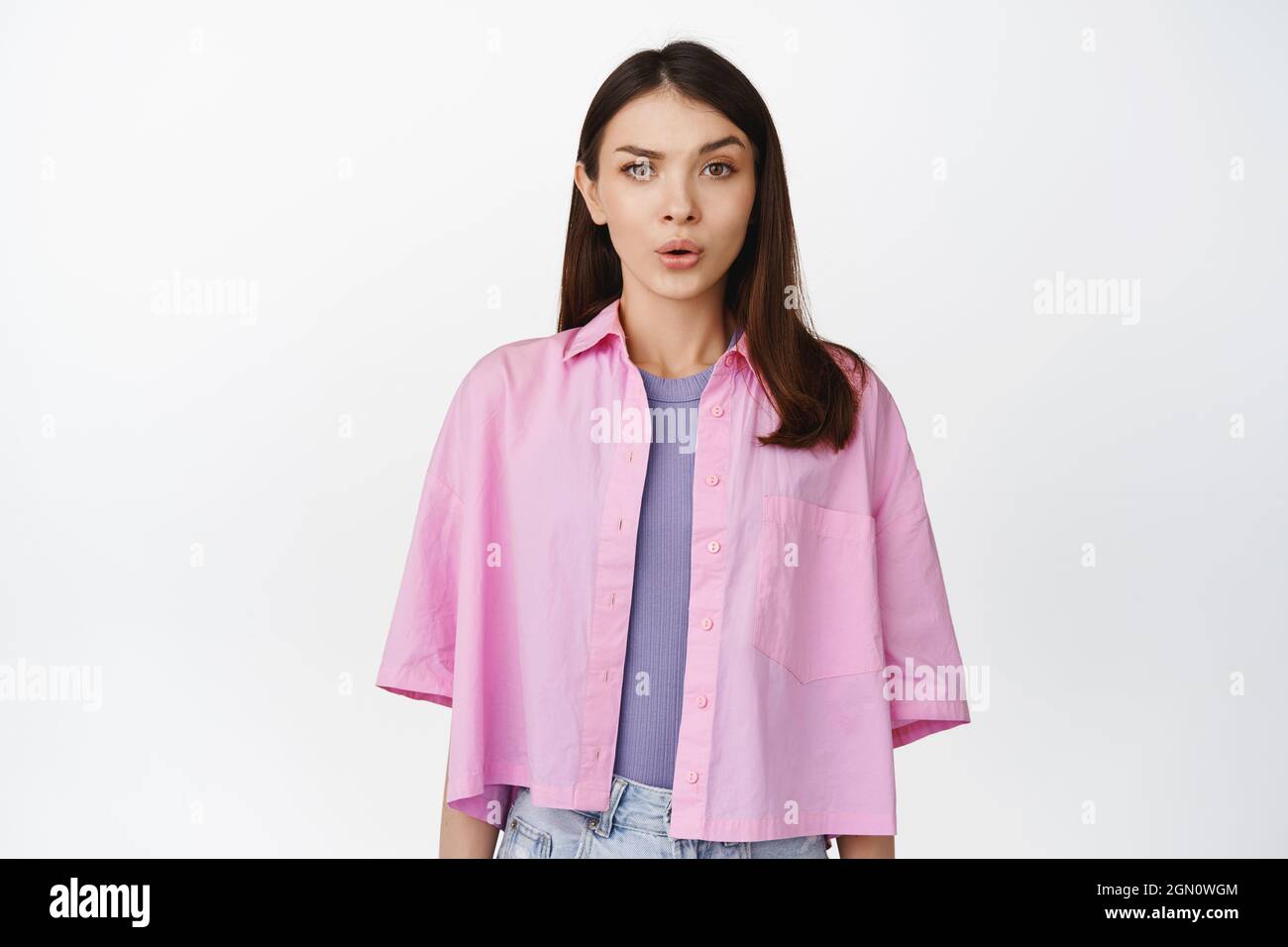 Confused brunette girl flick eyebrows, staring at something awkward or ...