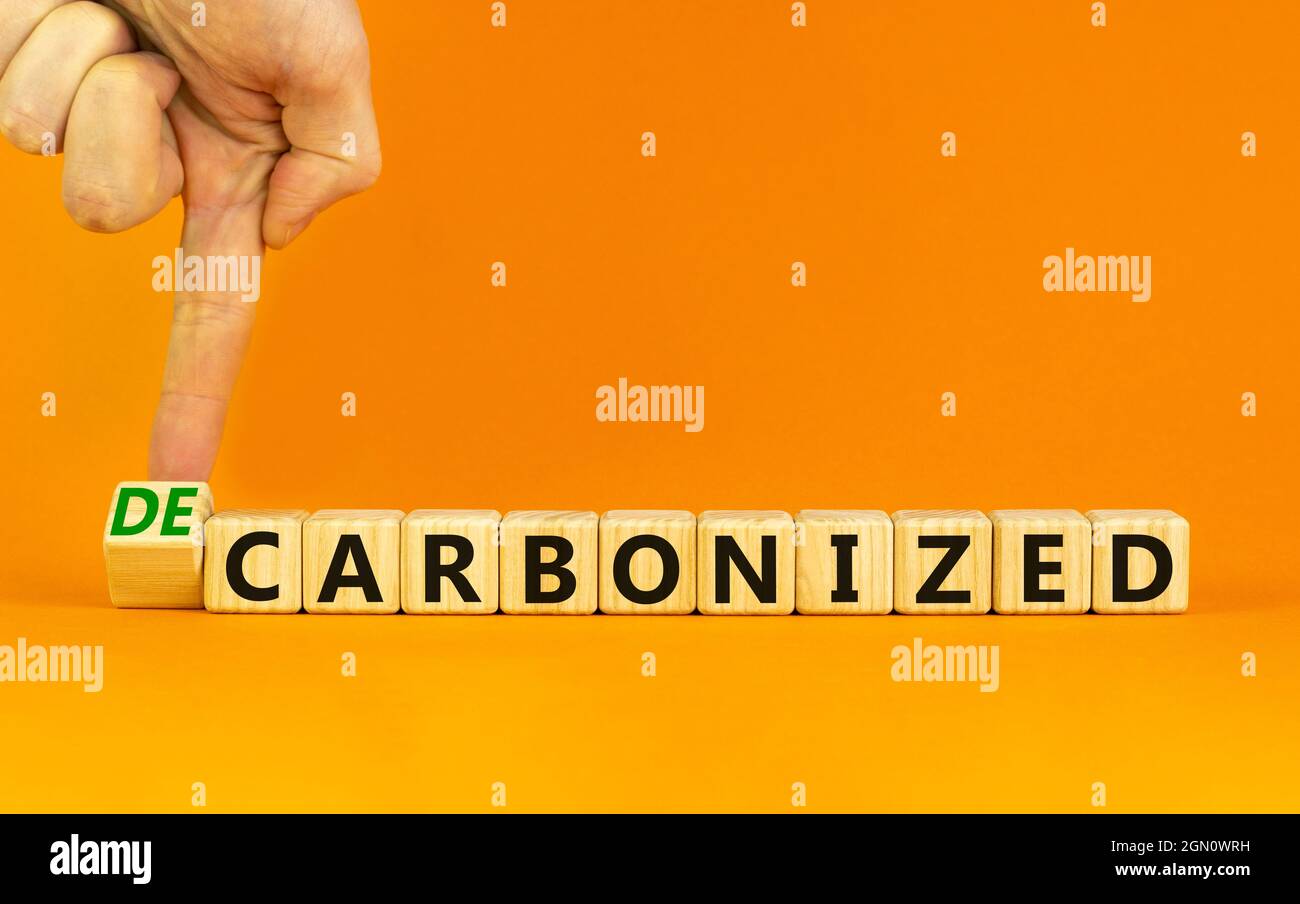 Carbonized or decarbonized symbol. Businessman turns a wooden cube and ...