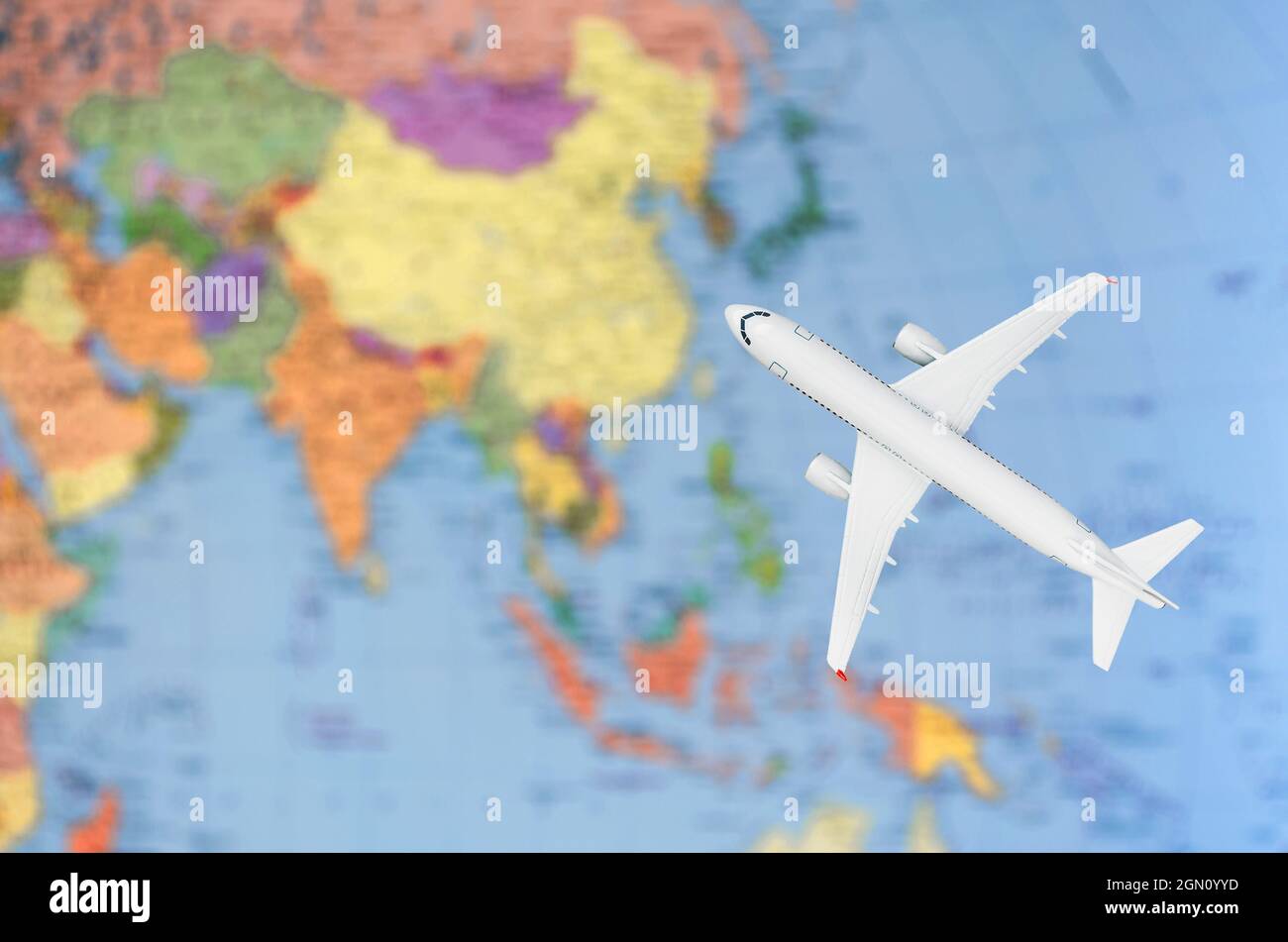 Flight to Asia symbolic image of travel by plane map Stock Photo - Alamy