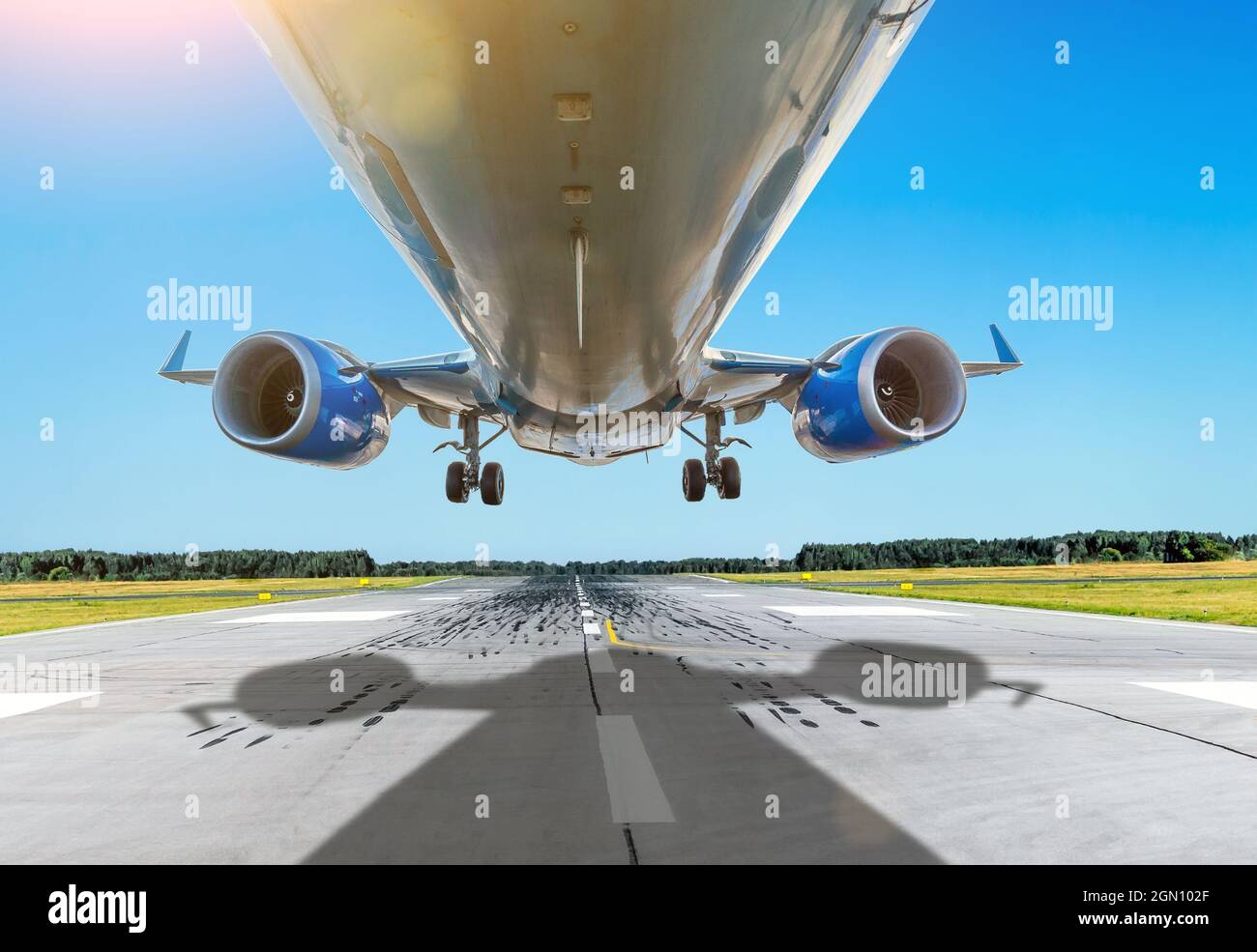 Passenger close up bottom airplane fly over the runway in good weather ...
