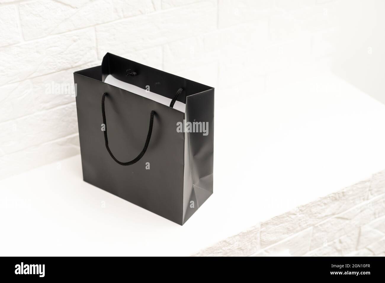 black paper bag with handles on a white background Stock Photo - Alamy