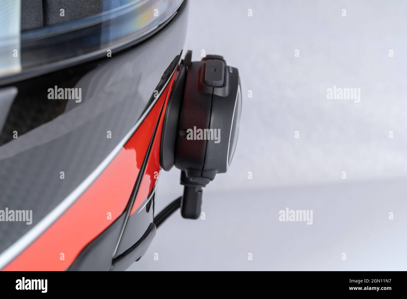 An intercom on a red motorcycle helmet isolated on white Stock Photo ...