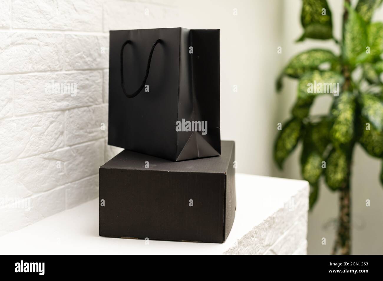 Black cardboard box over white background Stock Photo - Alamy