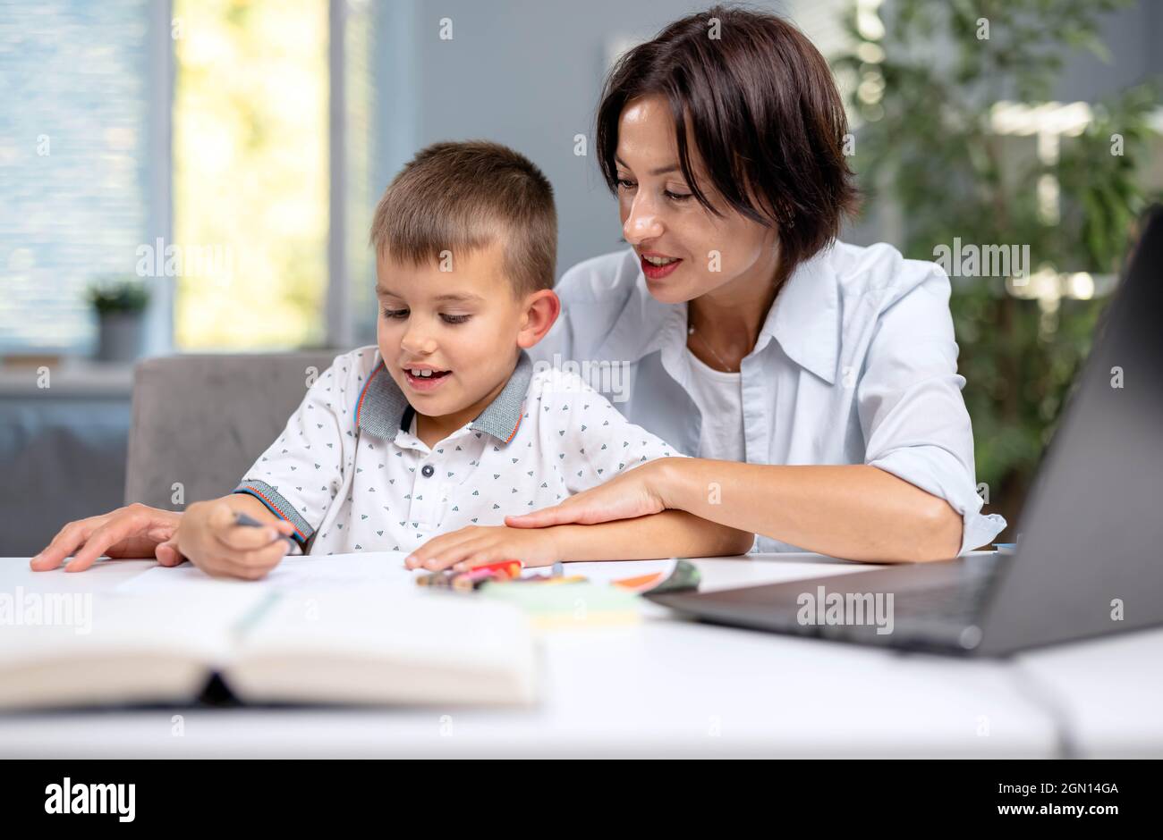 Mother helping son with homework Stock Photo - Alamy