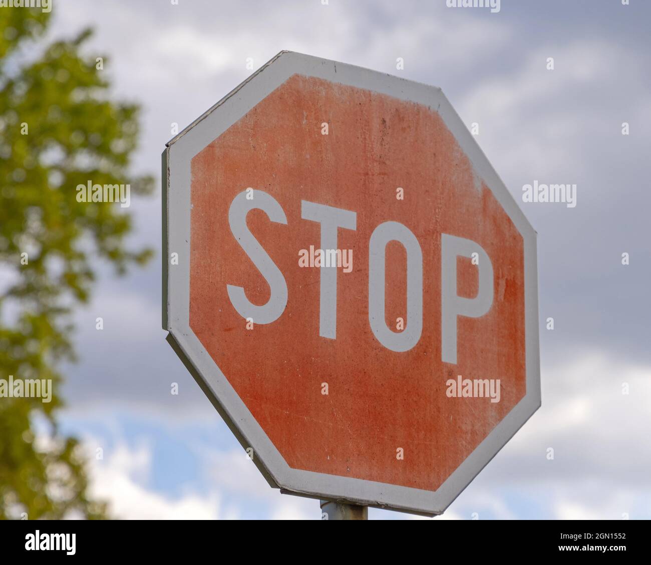 Faded Paint at Road Sign Stop Weather Damage Stock Photo - Alamy