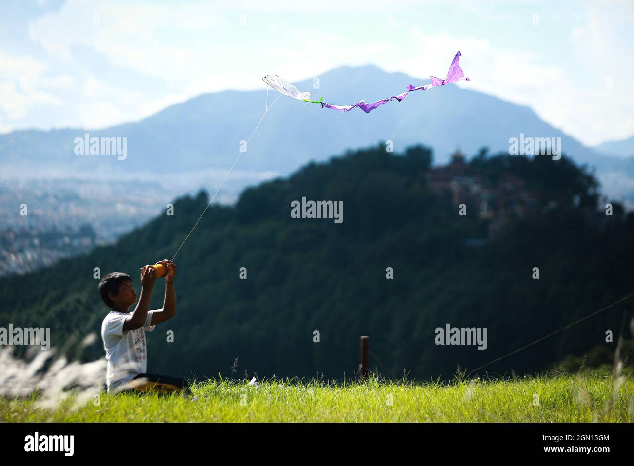 Bhaktapur, Nepal. 21st Sep, 2021. Boy fly a kite ahead of Dashain from ...
