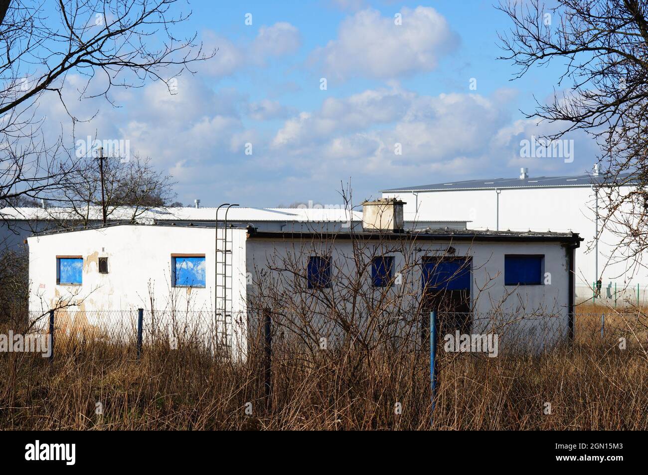 White building surrounded by brown grass under a cloudy sky Stock Photo ...