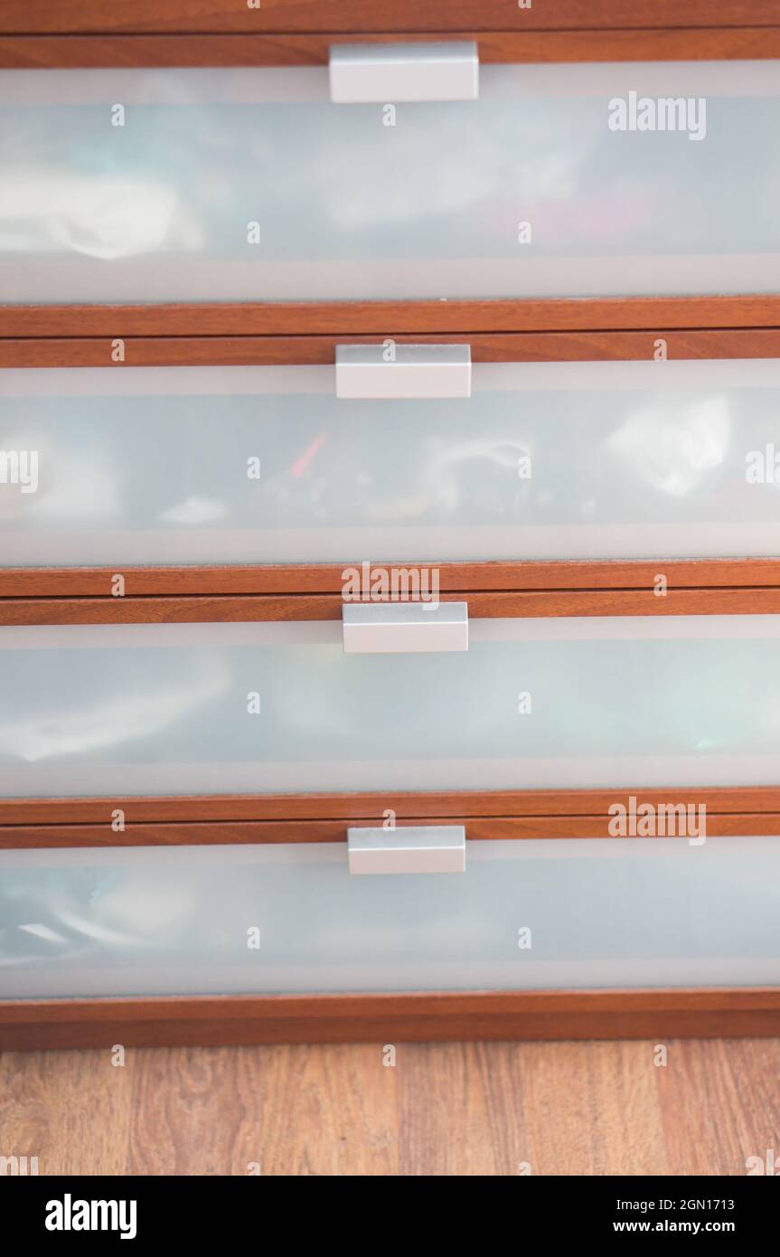 Vertical shot of the wooden closet shelves with handles Stock Photo - Alamy