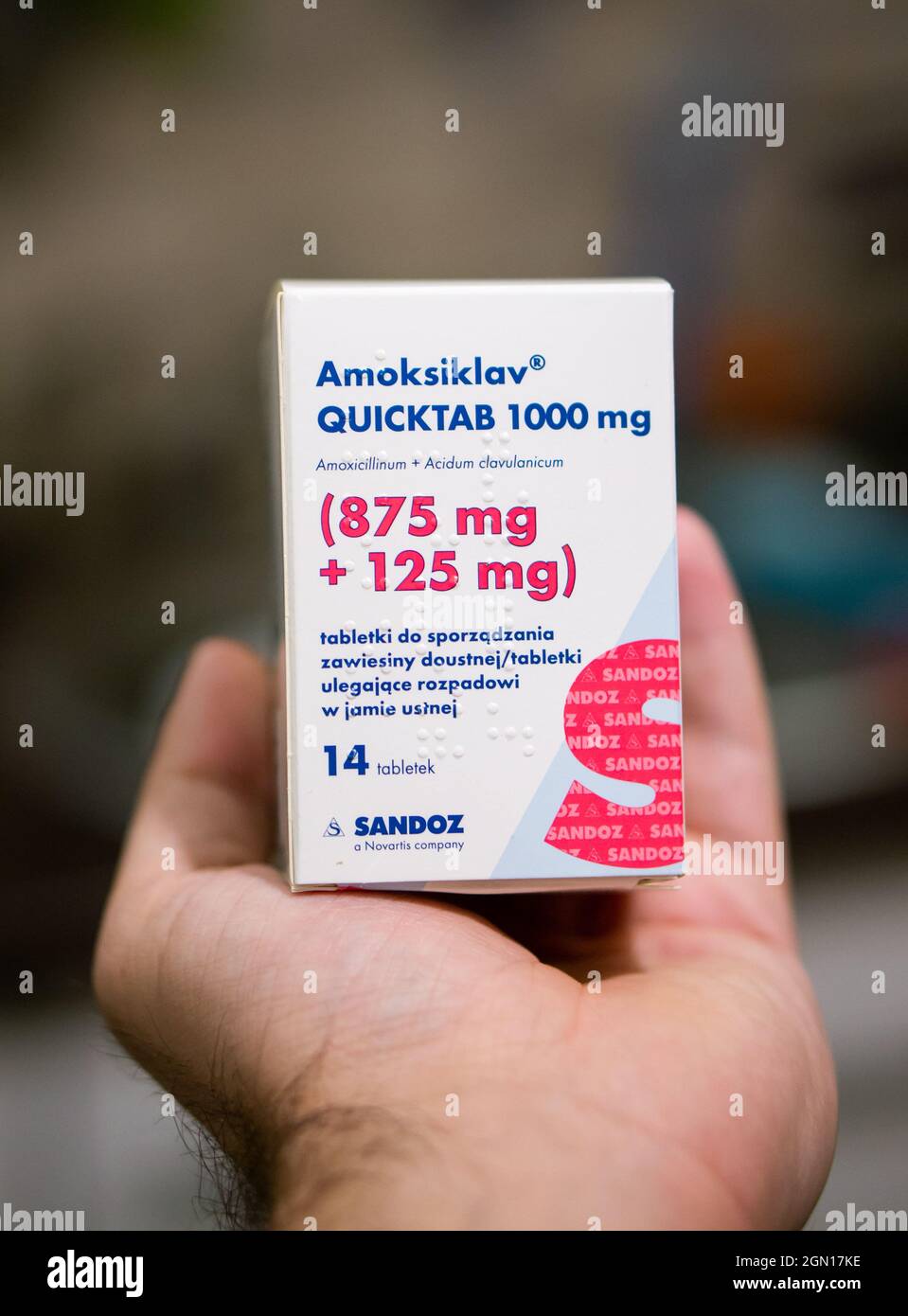 POZNAN, POLAND - Apr 11, 2018: A vertical shot of a hand holding ...