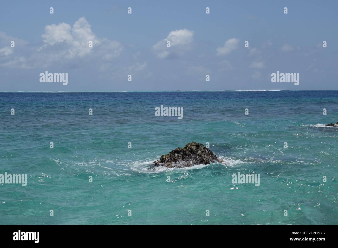A rock surrounded by water in the indian ocean Stock Photo - Alamy