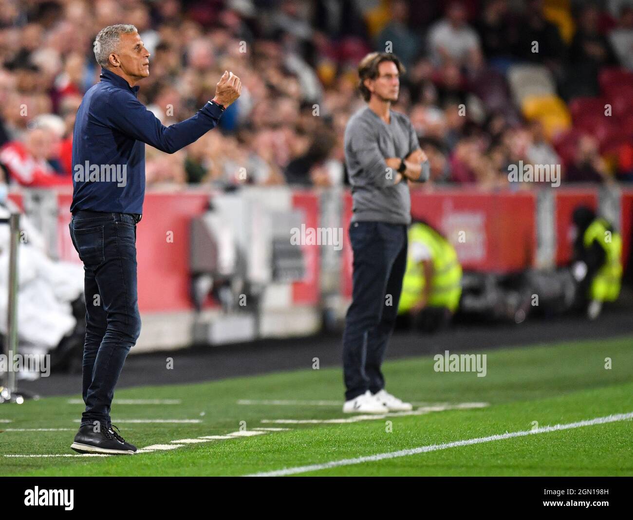 Oldham Athletic manager Keith Curle (left) and Brentford manager Thomas ...