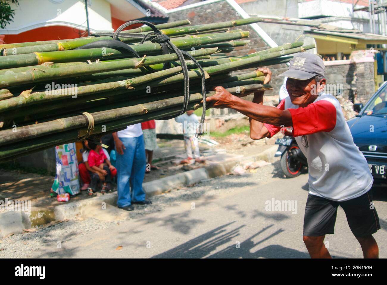 An Old Man Is Carrying Bamboo Sticks The Bamboos Were Carried In A