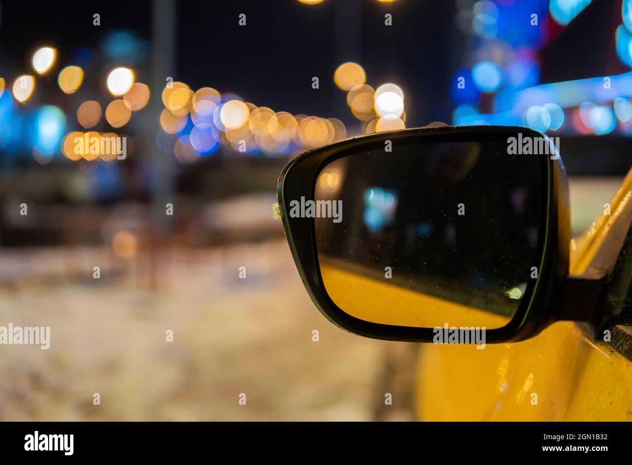mirror car yellow color on background lights night city Stock Photo - Alamy