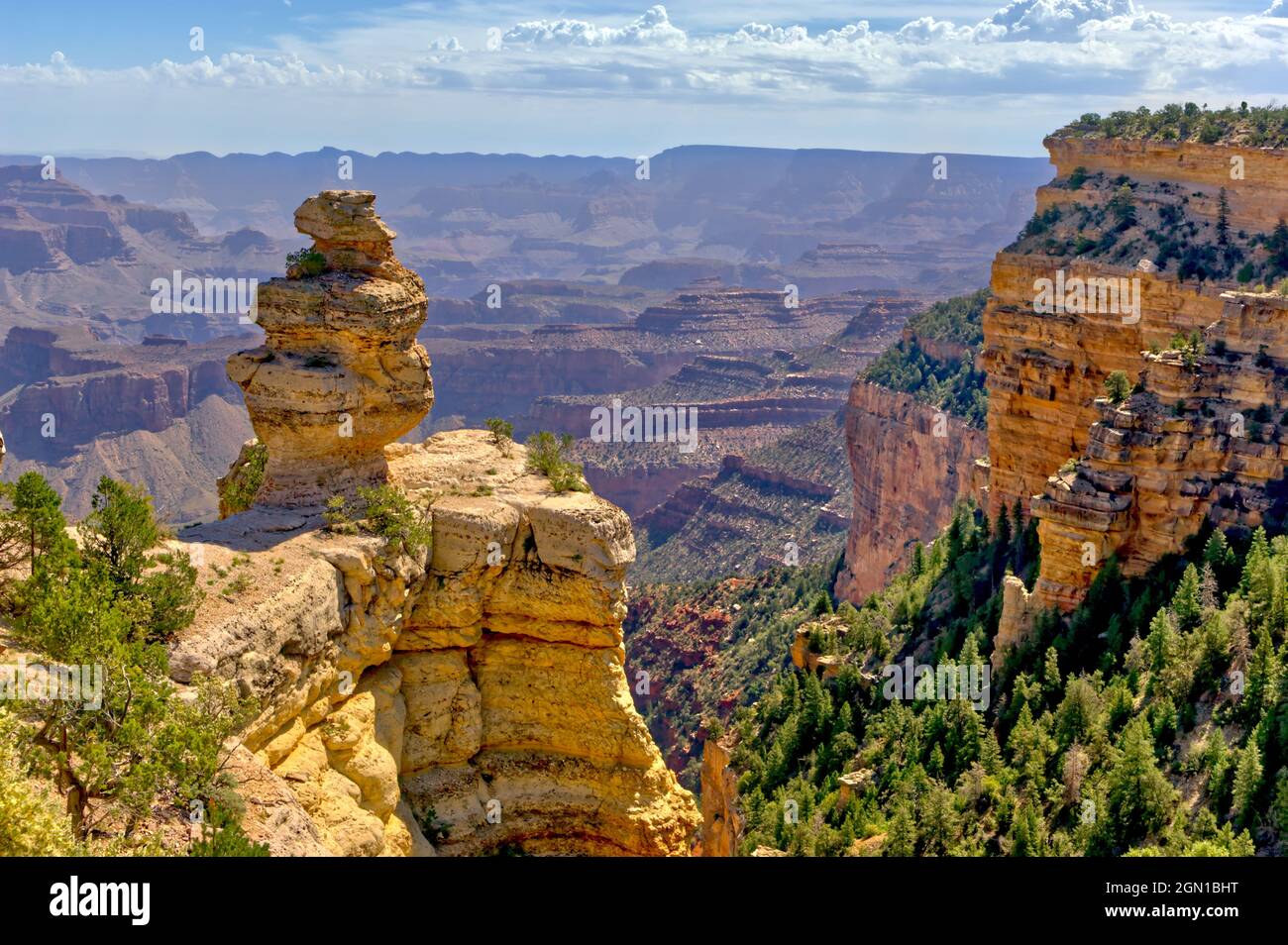 A precarious ledge of rock and pillars on the edge of the south rim of ...