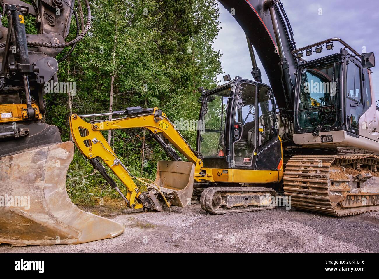 Small and big excavators, close up photo Stock Photo - Alamy