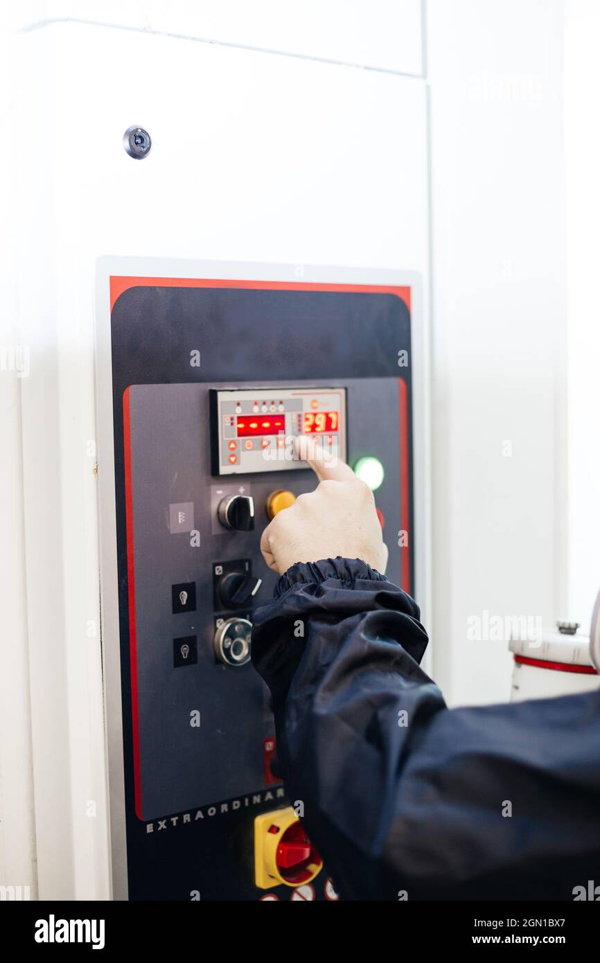 Male operator in front of machine operating console in factory Stock ...